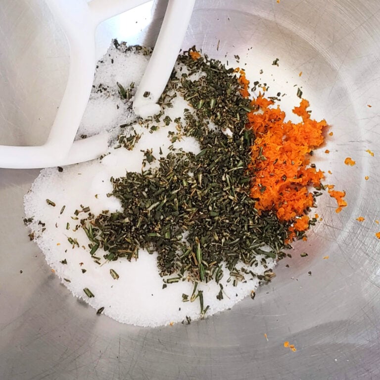 Add sugar, rosemary and orange zest to a mixing bowl. You’ll mix until ...